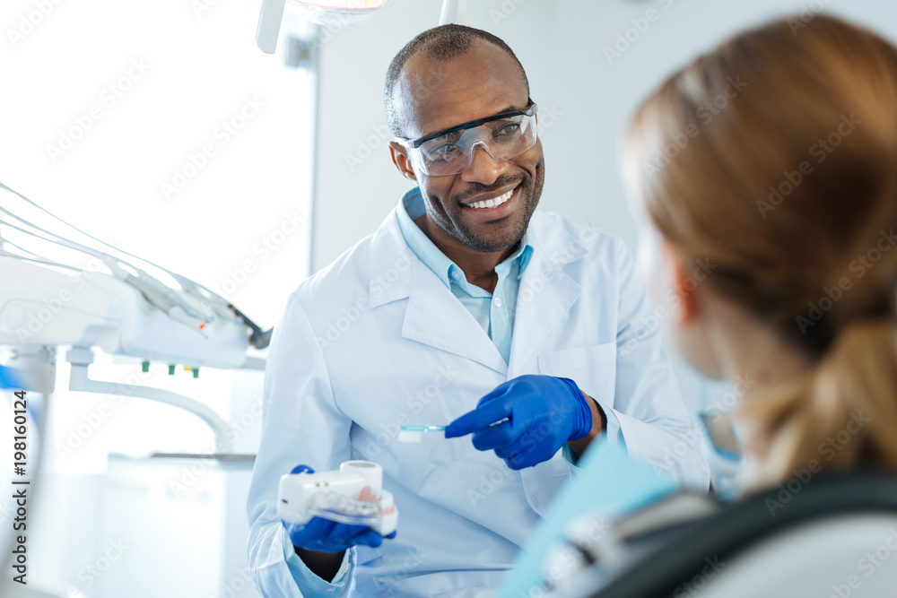 Great teacher. Pleasant young male dentist explaining his female ...