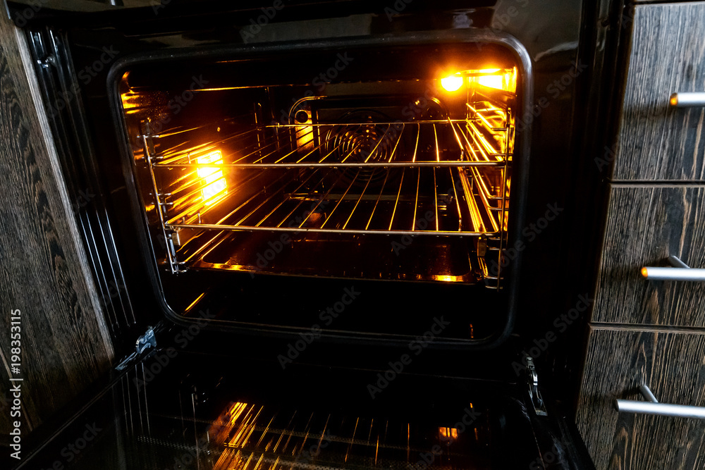 Empty open electric oven with hot air ventilation. New oven. Door is ...