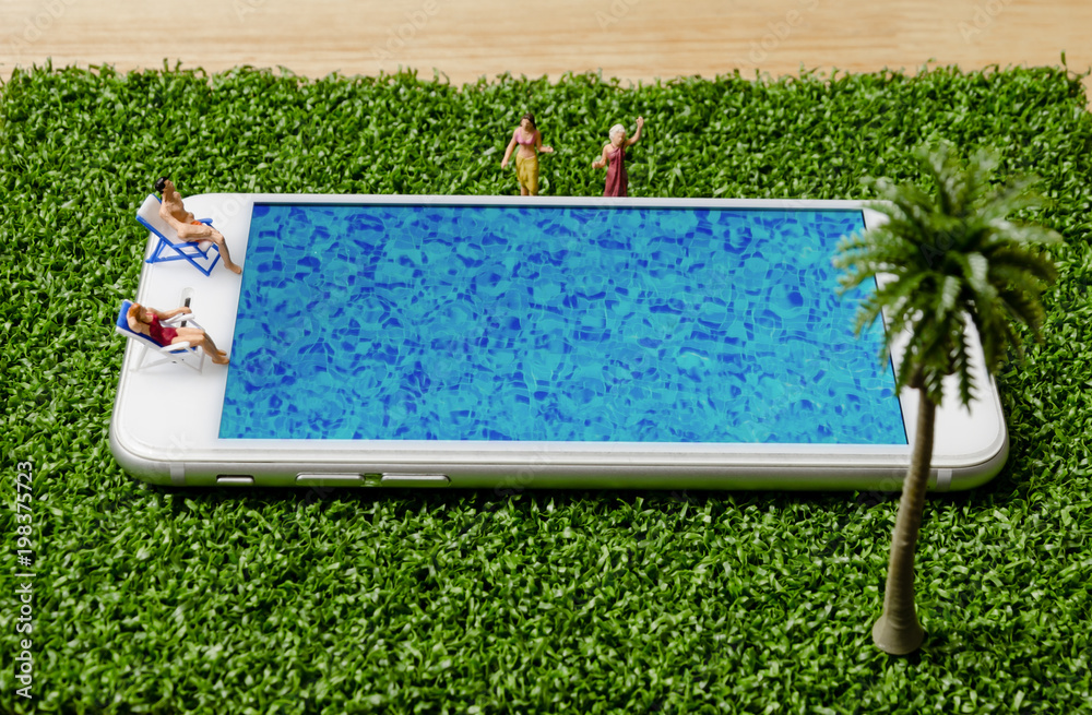miniature people in swimsuit sitting and relax on mobile phone swimming ...
