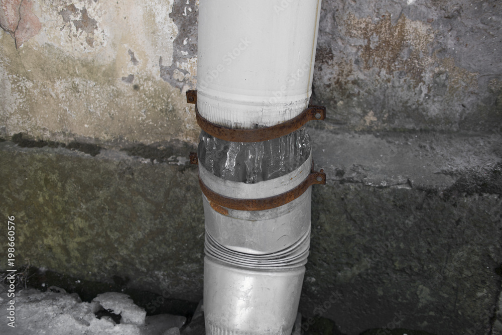 Damaged ice downpipe symbol poverty and decay Stock Photo | Adobe Stock