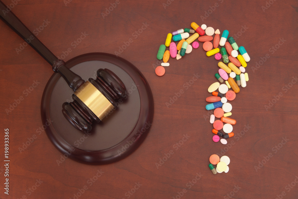 Question mark shaped drugs and pills with judge gavel with drugs on ...