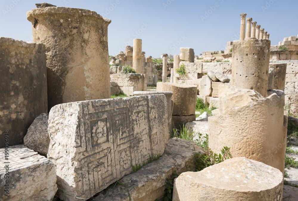 Ancient pattern on a stone block and the remains of the ruined ancient ...