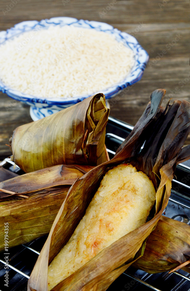 Grilled stuffed Glutinous rice wrapped in banana leaves or sticky rice ...