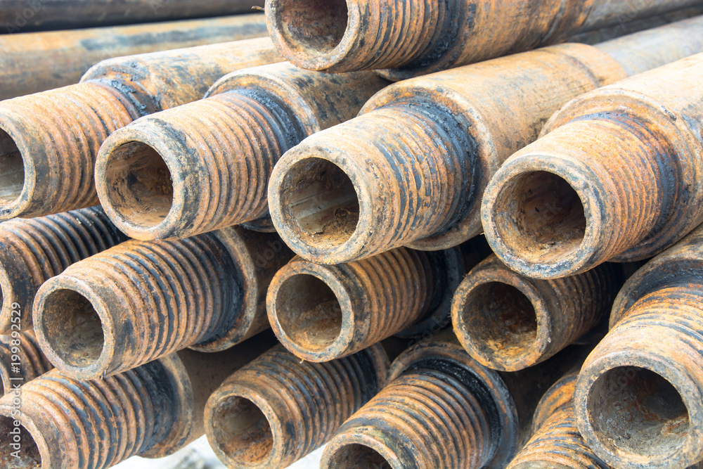 Drill pipes are located horizontally on the rack. In the foreground, a ...