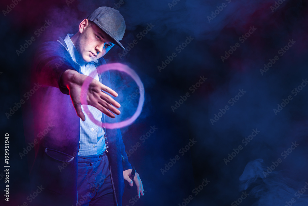 Vaping. Vape trick rings in performance of vaper on red blue background ...