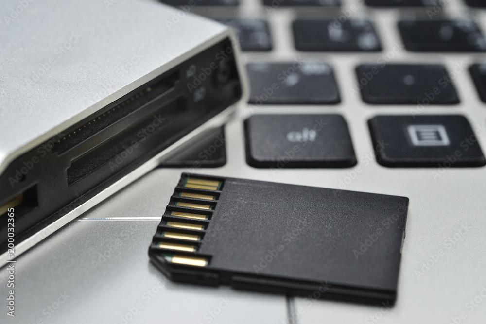 SD card and card reader on keyboard notebook background Stock Photo ...