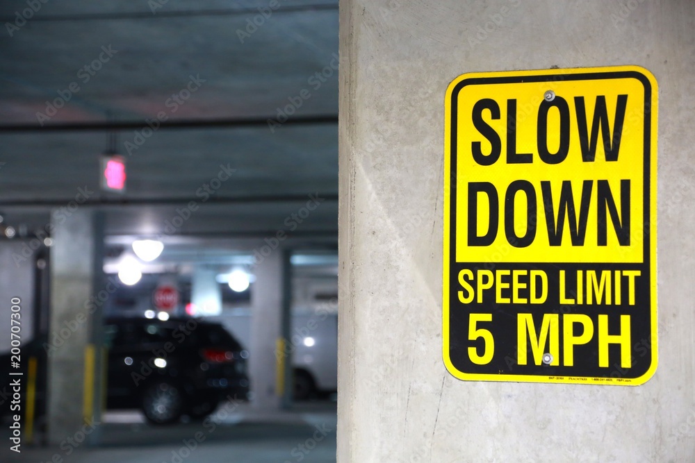 Yellow and Black Slow Down Speed Limit 5 Mph Sign in a Parking Garage ...