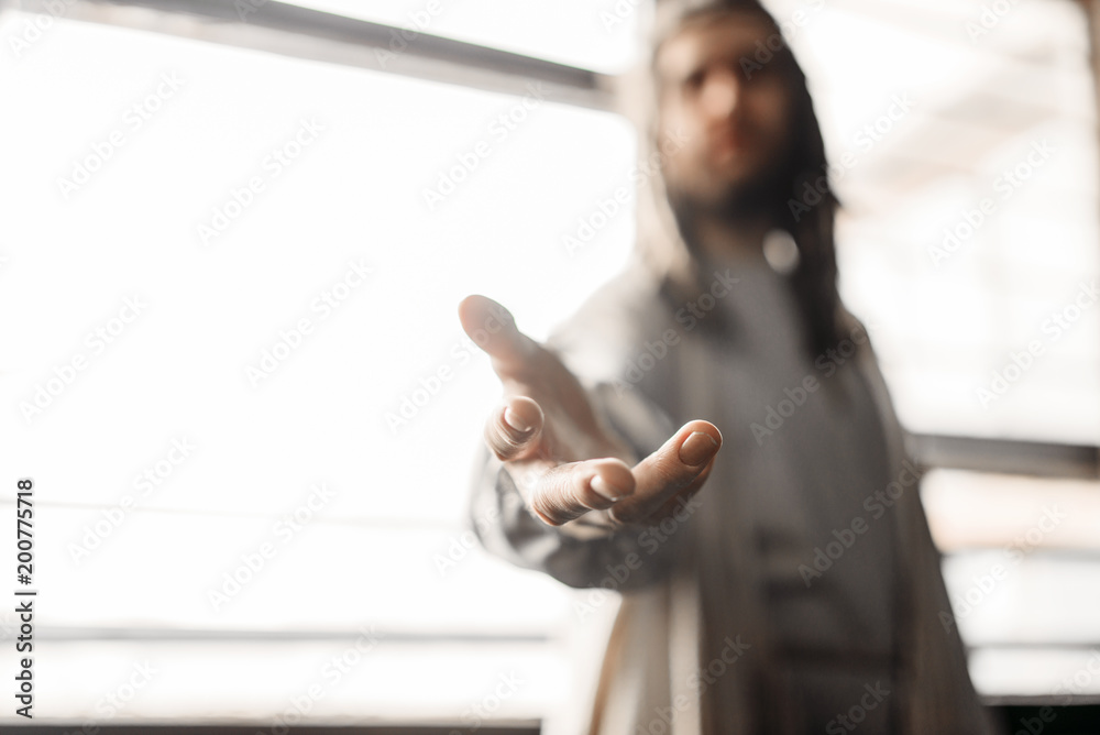 Jesus Christ in white robe reaching out his hand Stock Photo | Adobe Stock