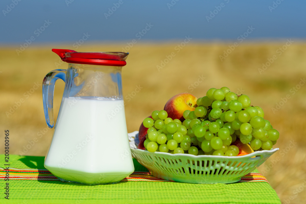 Photo Stock First fruits habikkurim in hebrew and jug of milk on table ...
