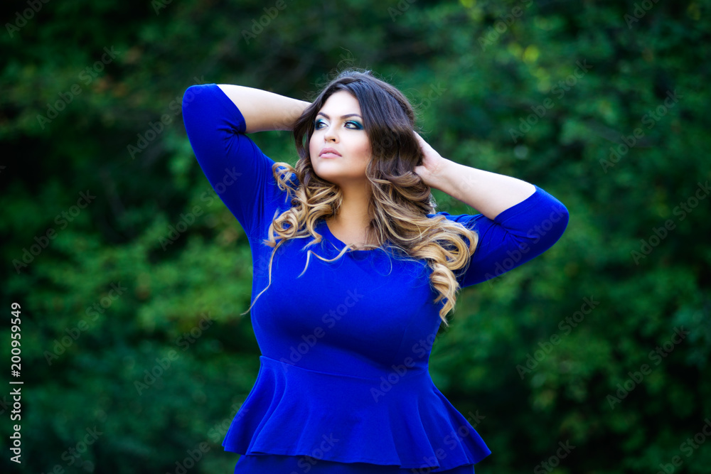 Plus size fashion model in blue dress outdoors, beauty woman with ...