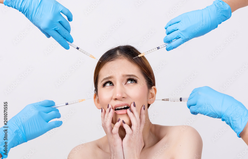 Attractive woman scared of injection. Girl looking with fear at a ...