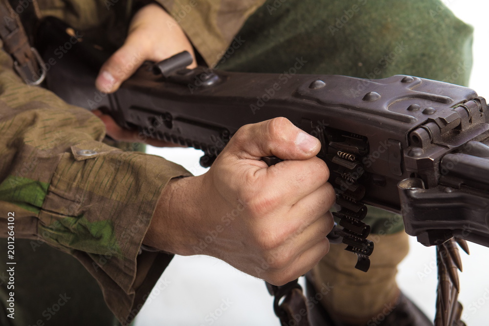 Man actor in the movie role of an old military man with a MG 42 machine ...