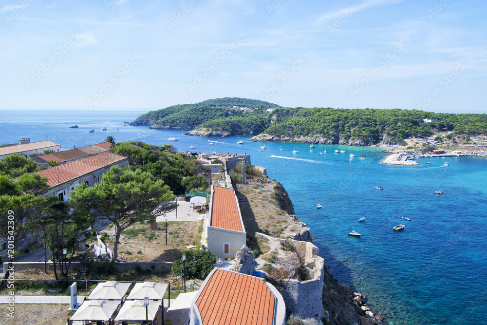 view of Tremiti islands with blue water, boats and clouds. Gargano ...