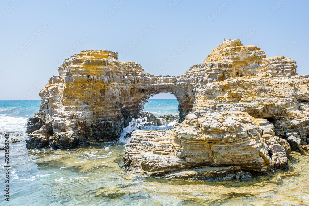 Beautiful sunny coast view to greek beach with rocky arch cove and ...