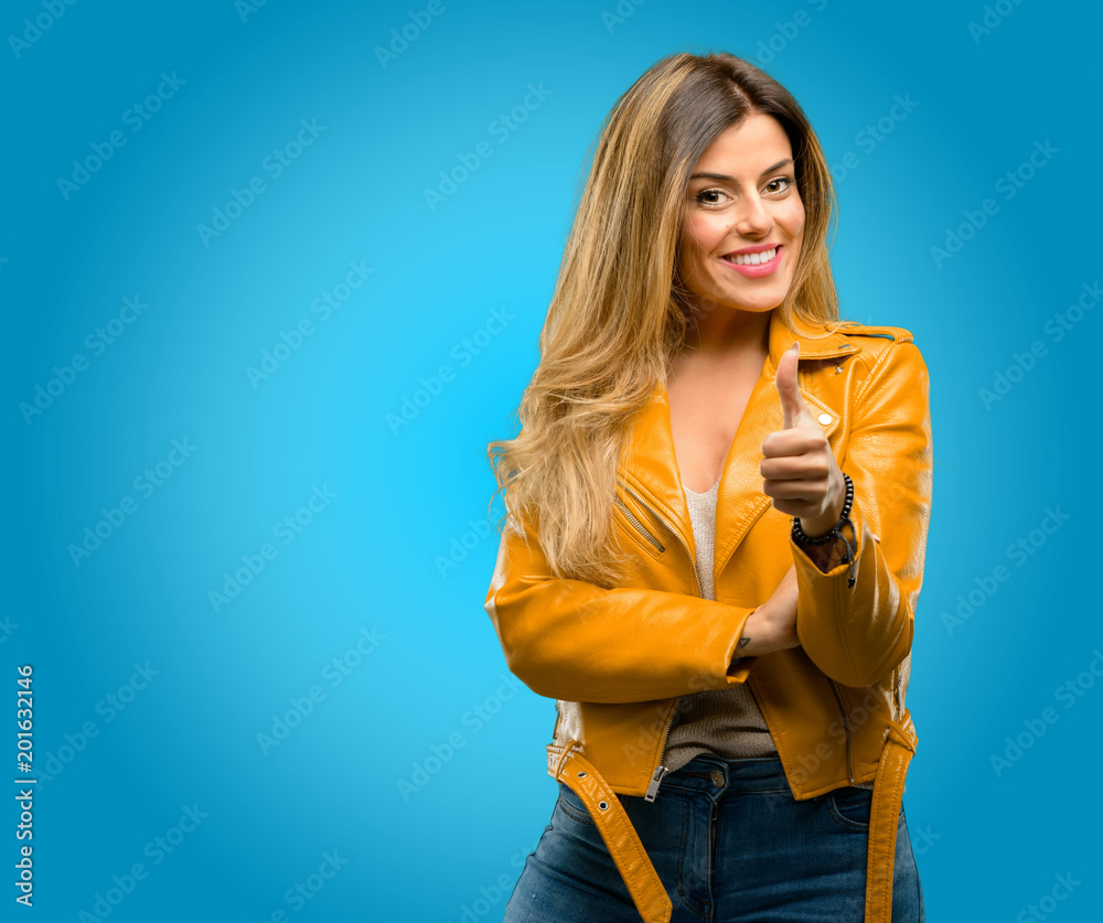 Beautiful young woman smiling broadly showing thumbs up gesture to ...