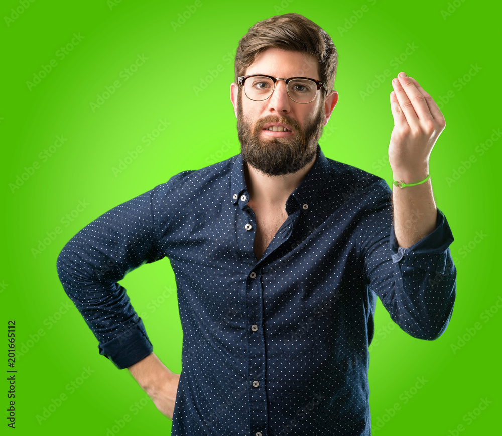 Young hipster man with big beard angry gesturing typical italian ...