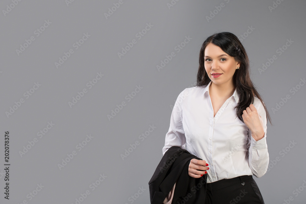 Portrait of a beautiful young business woman standing with hand holding ...