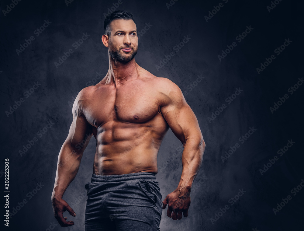 Portrait of a shirtless tall huge male with a muscular body with a ...