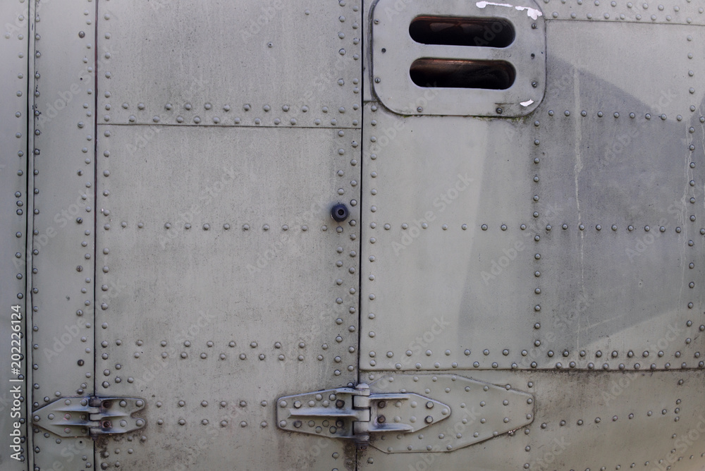 Old silver metal surface of the aircraft fuselage with rivets. Fuselage ...