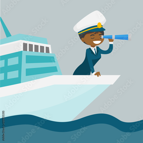 Young black female ship captain in uniform standing on the bow of the ...