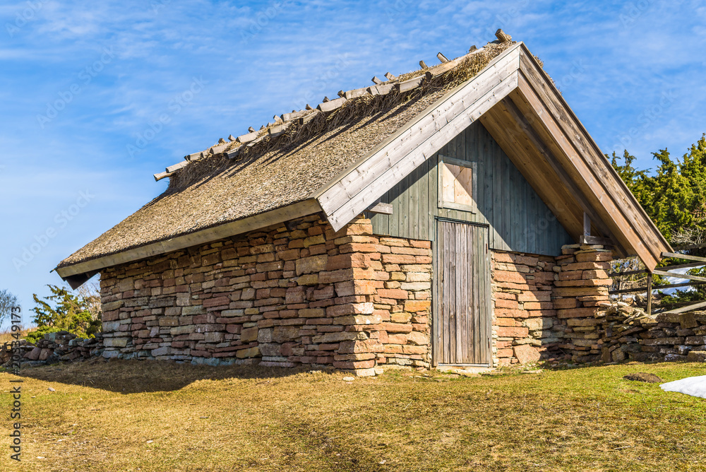 Fishing cabin made of stacked limestone slabs and thatched straw roof ...