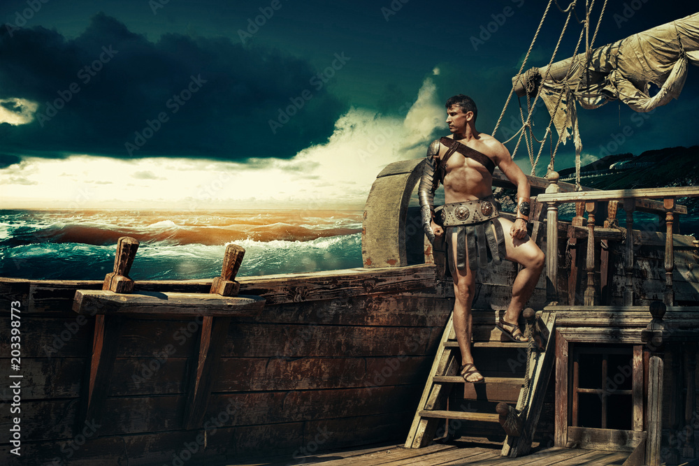 The muscular man in Roman armor. gladiator in armour. concept of ...