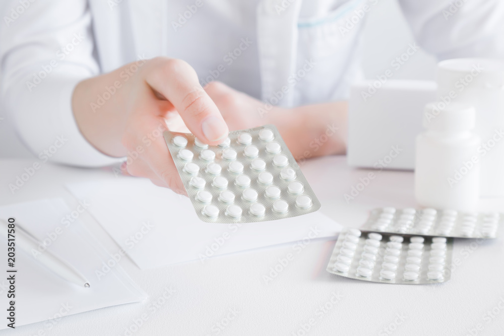 Doctor giving pills for treatment of patient. Visit to physician at ...