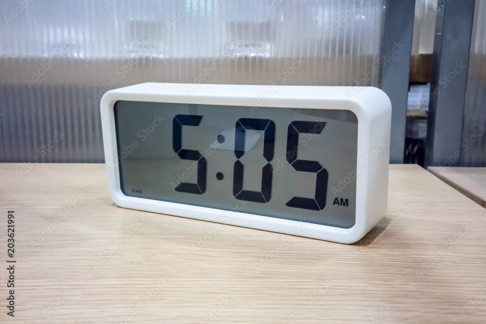 White pocket digital clock on wooden shelf Stock Photo | Adobe Stock