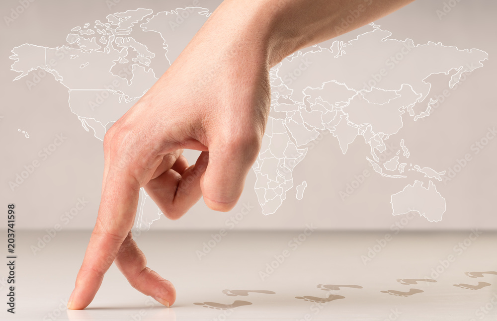 Female fingers walking with footsteps behind them and a world map in ...