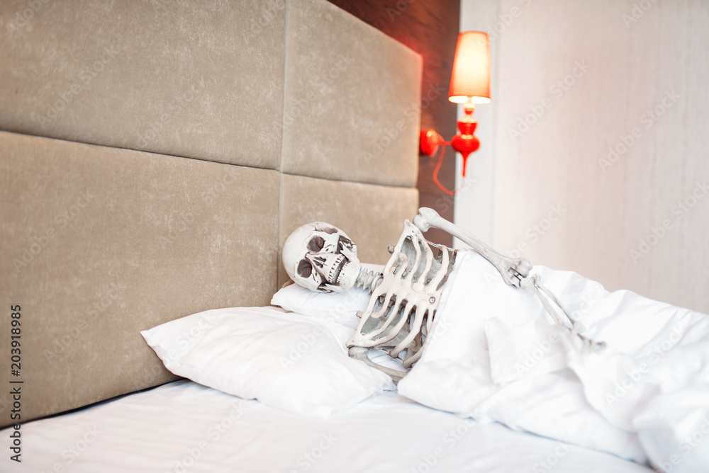 Funny human skeleton is lying in bad Stock Photo | Adobe Stock