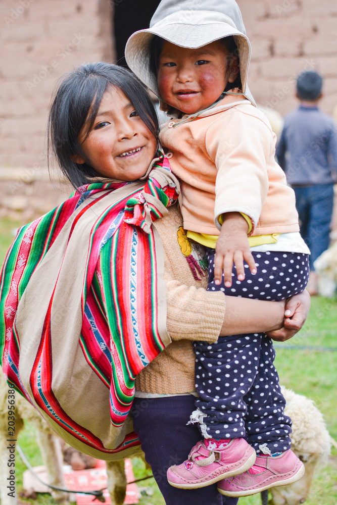 Foto de Stock Native american girl with typical aymara cloth holding ...