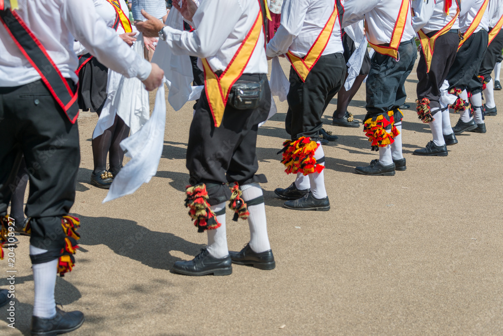 diagonal line of traditional english morris dancers wearing plus fours ...