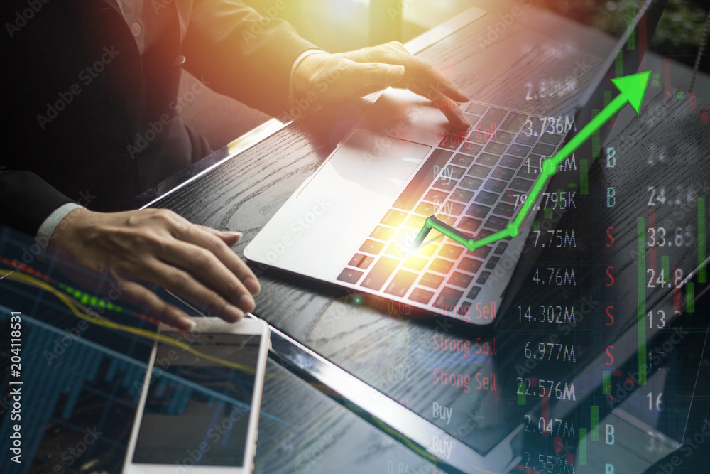 Investing on laptop and stock market concept gain with profits and ...