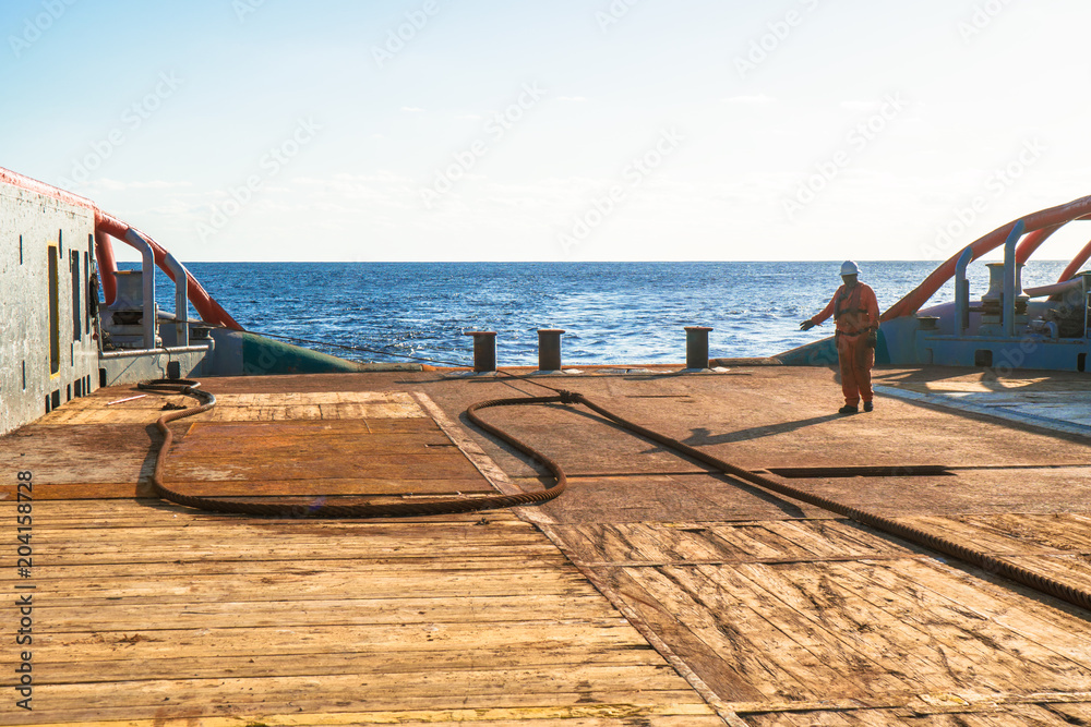 Anchor-handling Tug Supply AHTS vessel crew preparing vessel towing ...
