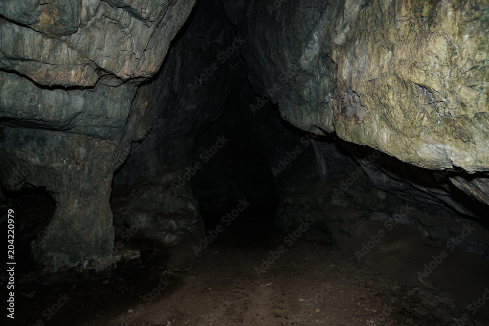 Beautiful cave. View from inside dark dungeon. Textured walls of cave ...