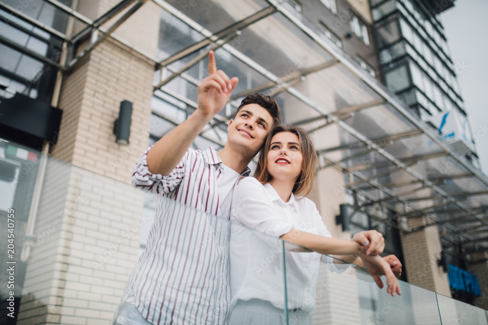 Real estate and family concept. Young couple pointed side on front of ...