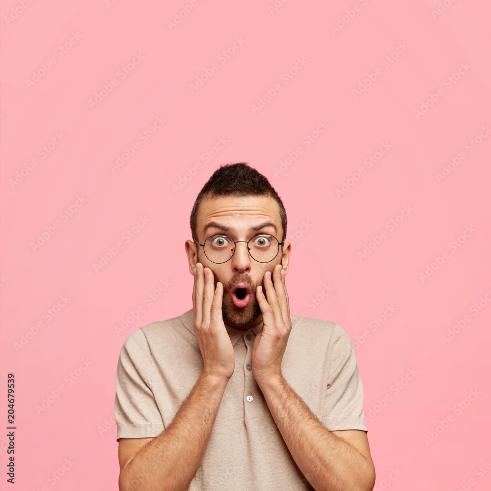 Photo of stunned stupefied male has bristle, looks with eyes popped out ...