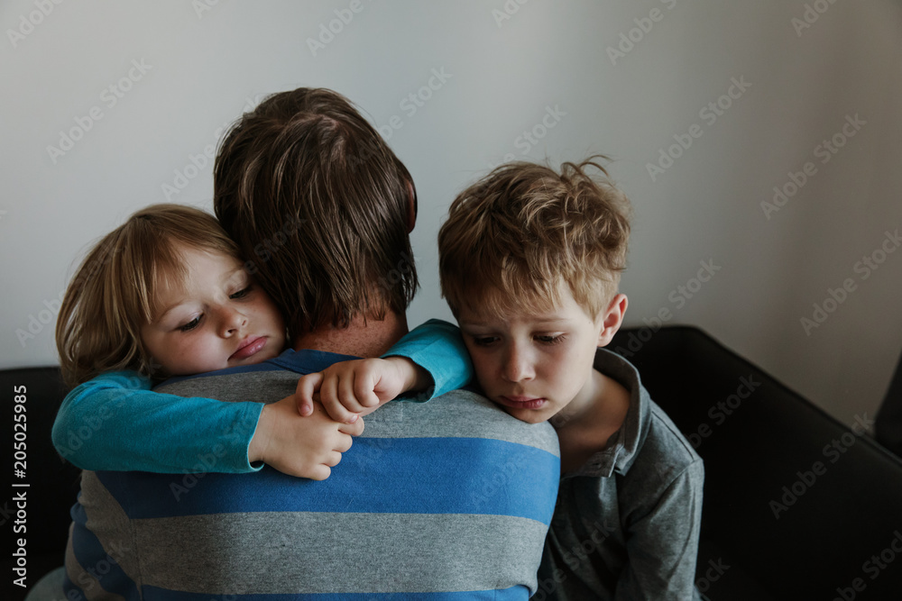 sad little boy and girl hugging father, family in sorrow Stock Photo ...