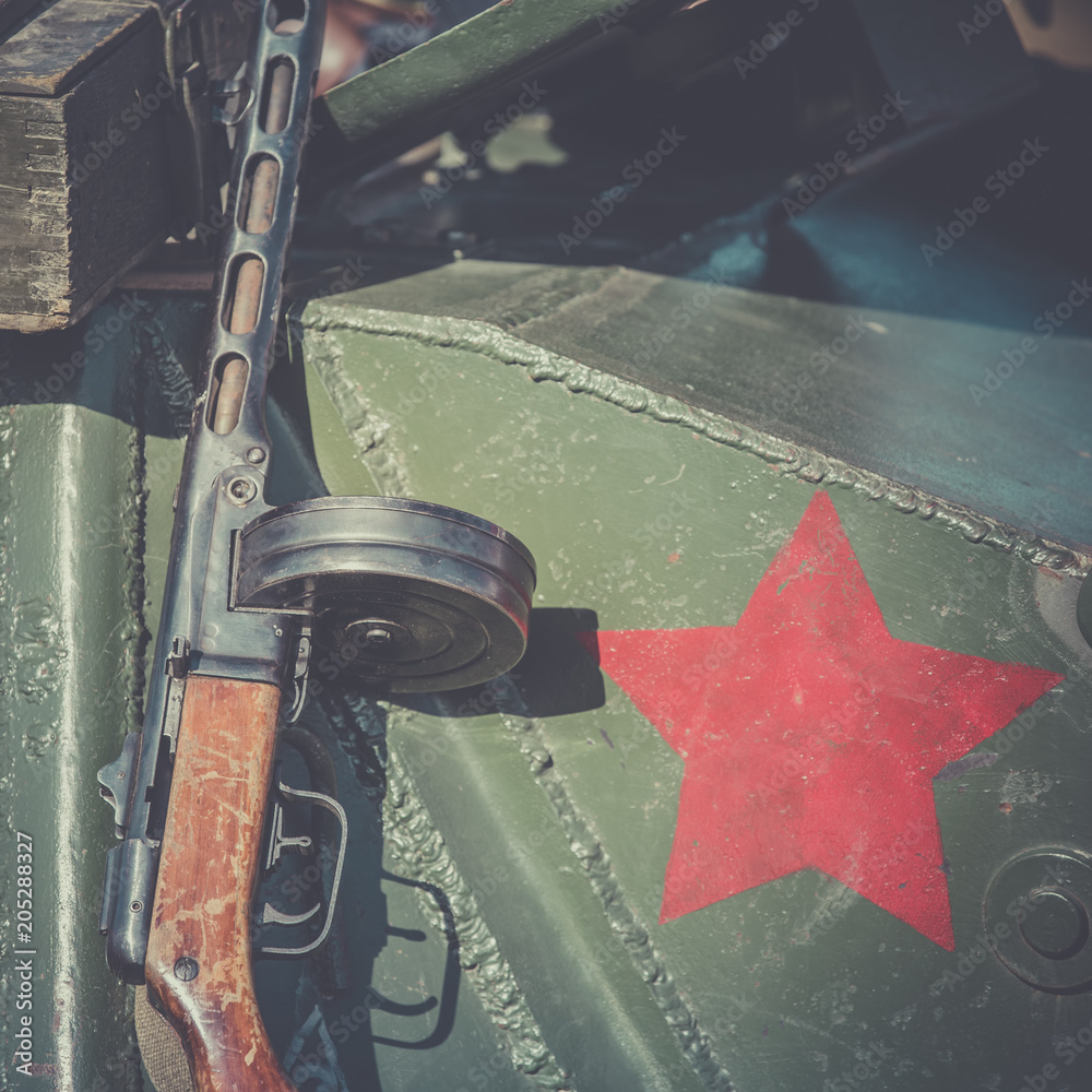 Submachine gun of Shpagin, PPSh is leaning against the armor of a tank ...