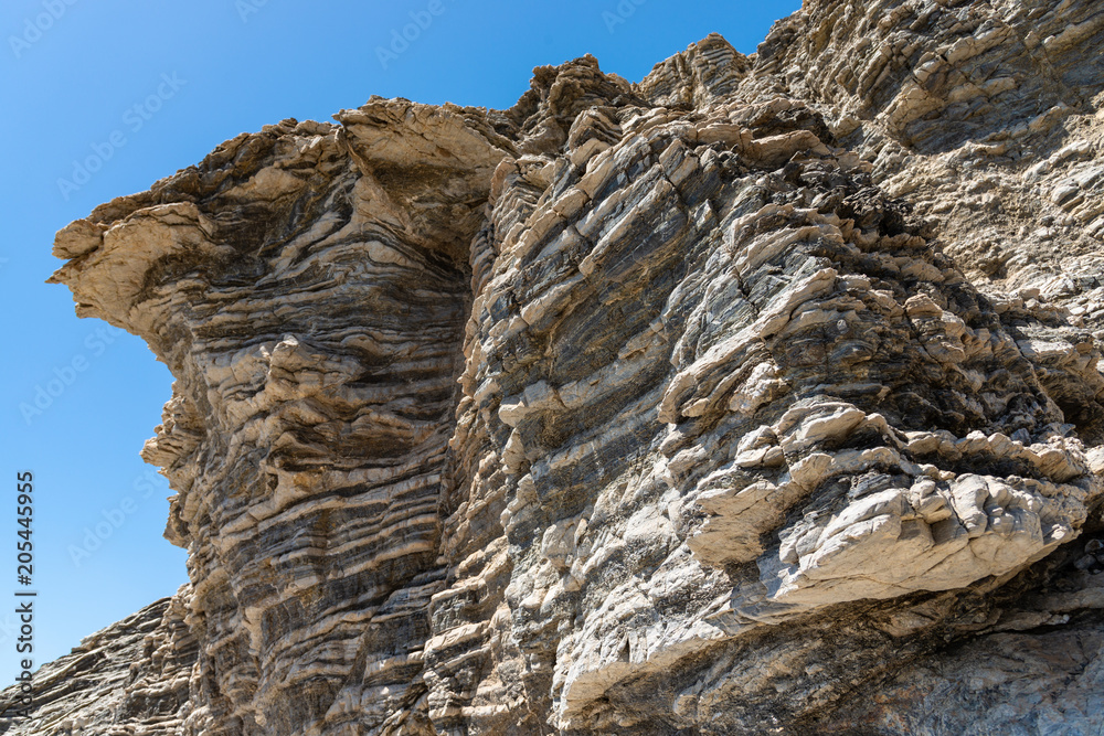 Compressed rock layers formation in various colors and thicknesses, on ...