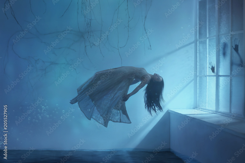 A ghost girl with long hair in a vintage dress. Room under water. A ...