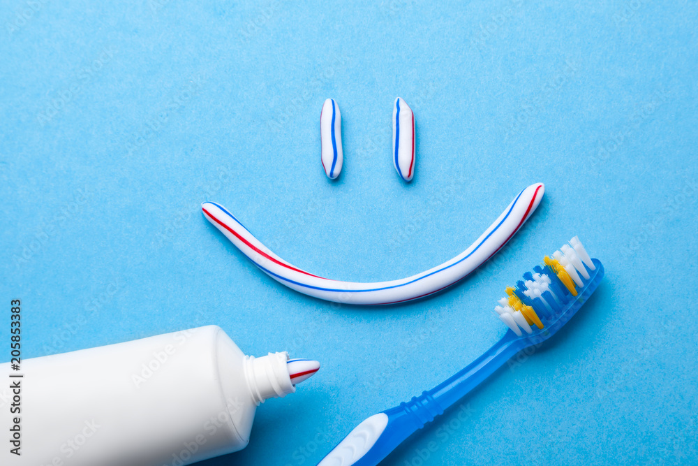 Tooth-paste in the form of a face with a smile. Tube of toothpaste and ...