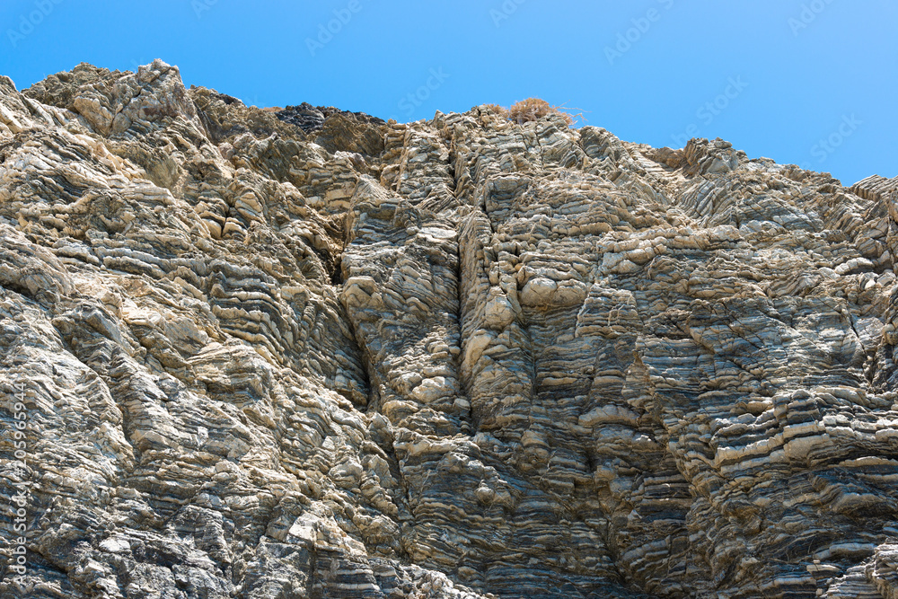 Compressed rock layers formation in various colors and thicknesses, on ...