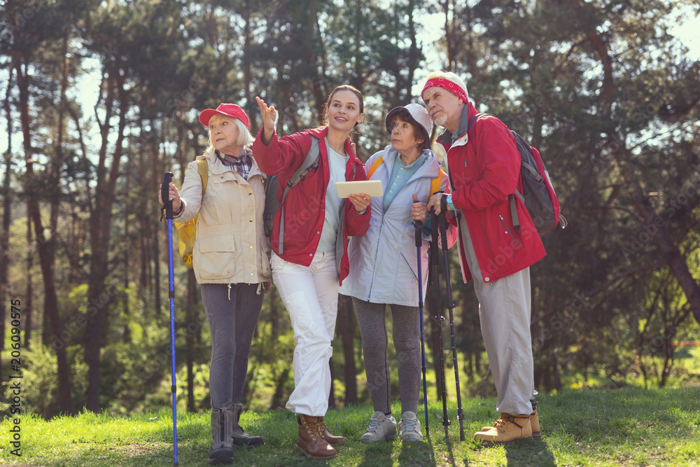 Defining the way. Inspired female guide showing the way and holding a ...
