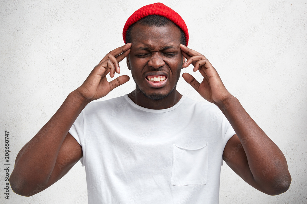 Negative feelings concept. Stressful dark skinned young man frowns face ...