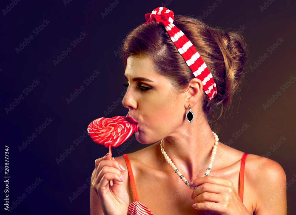 Woman eating lollipops. Girl in pin-up style hold striped candy. Pin up retro female style ...