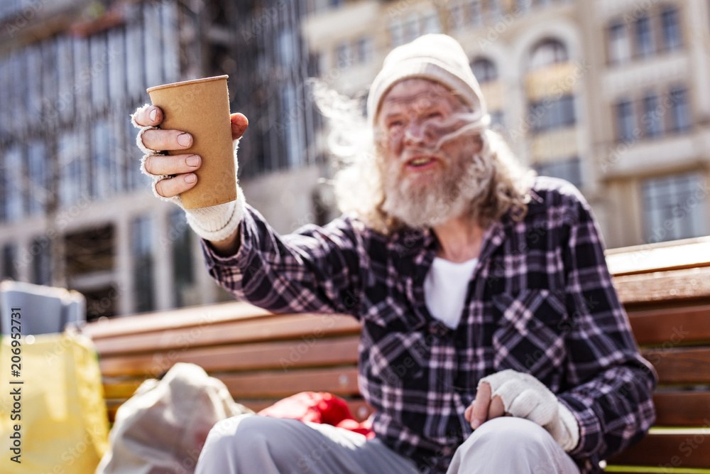 Street begging. Selective focus of a cup for money donations being used ...