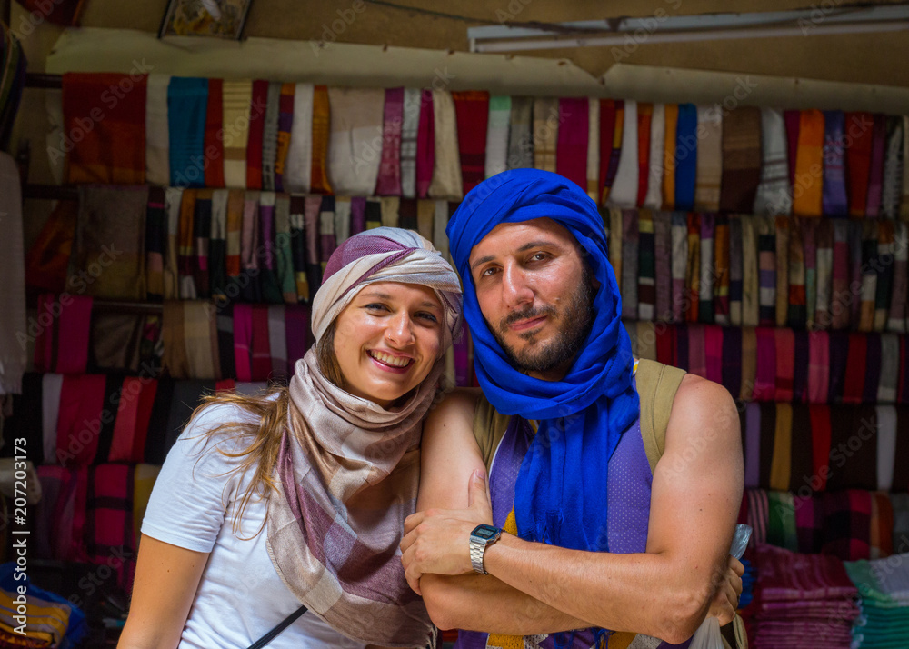 Tourist visiting Fez in the middle of souk, traditional leather tannery ...
