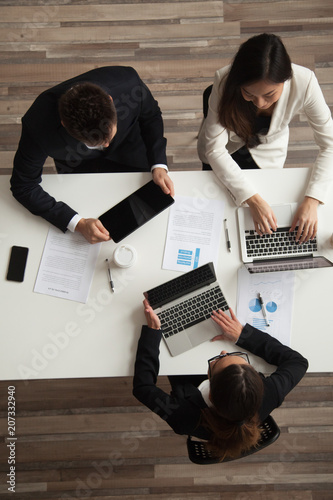 Three colleagues collaborating working online together at meeting using ...
