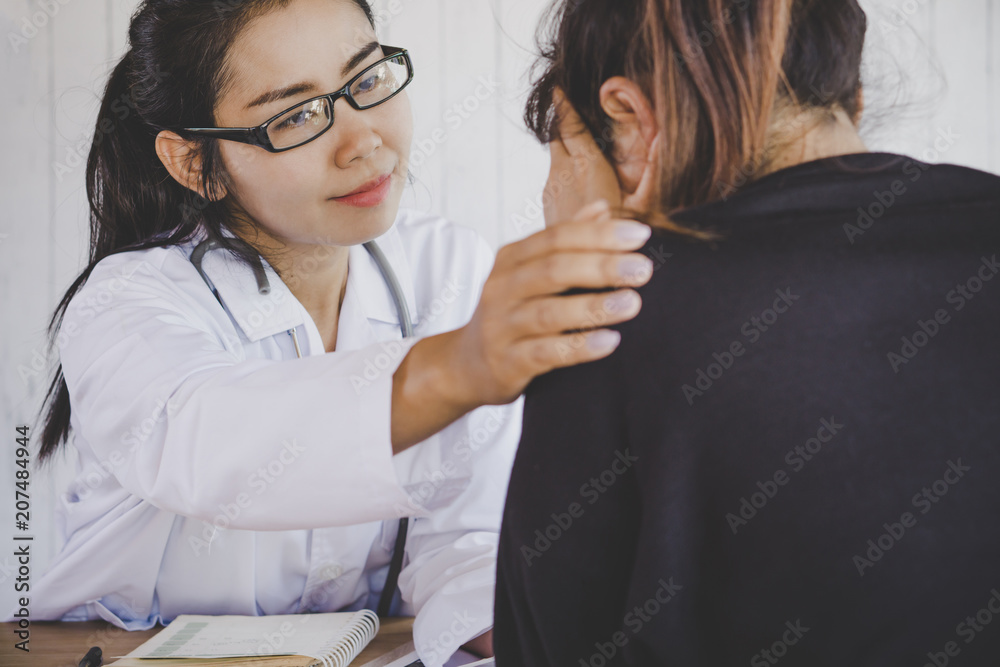 Asian female doctor comforting depressed patient at a hospital after ...